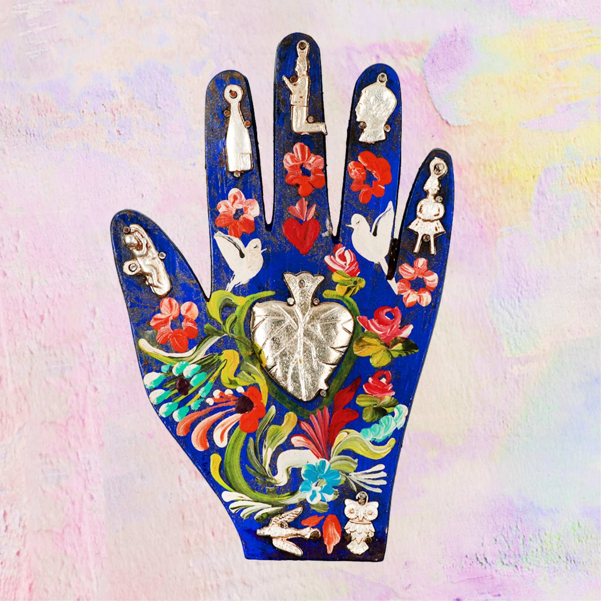 Wooden hand with Milagros